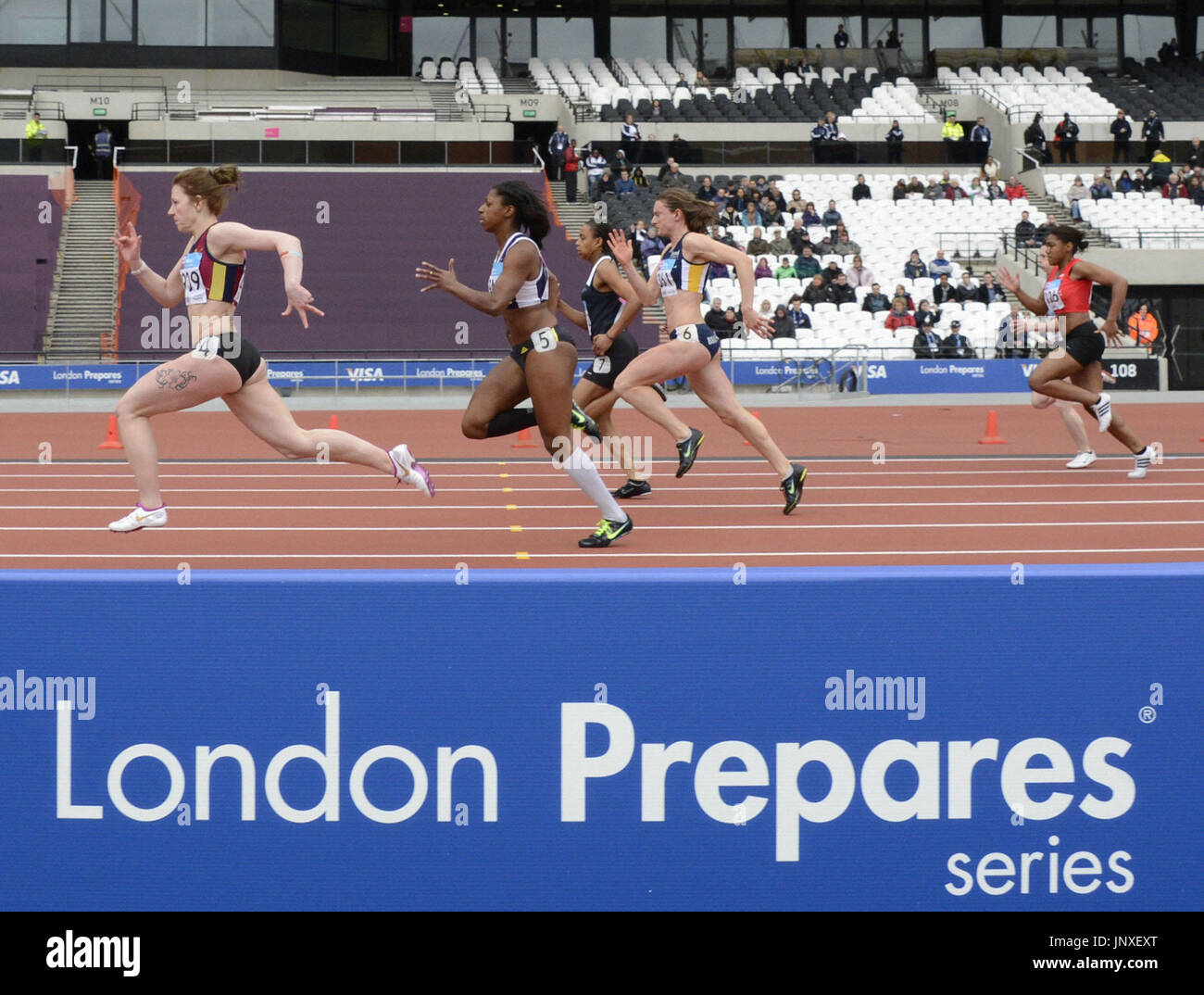 LONDON, Britain - Runners race in front of the main stand of the ...