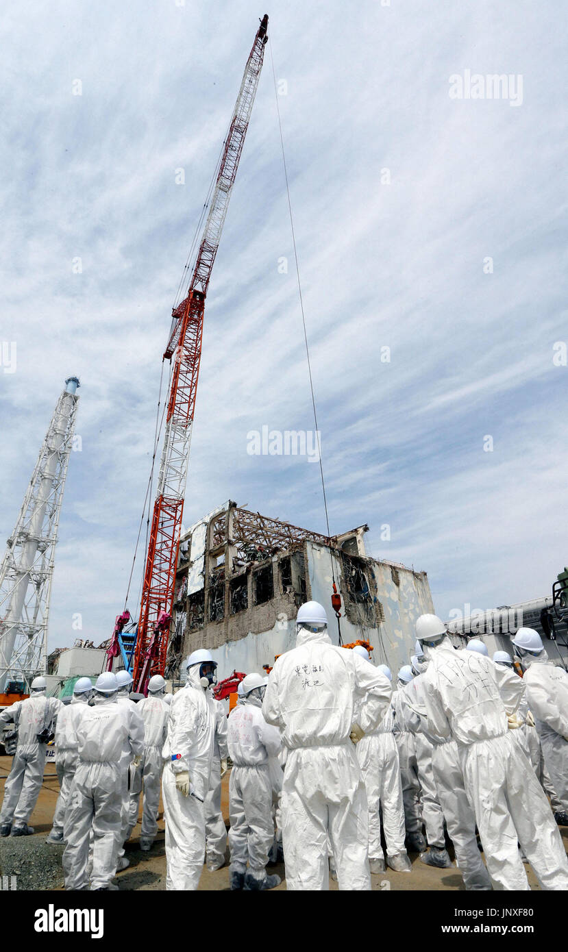TOKYO, Japan - A group of reporters view the wrecked reactor building ...