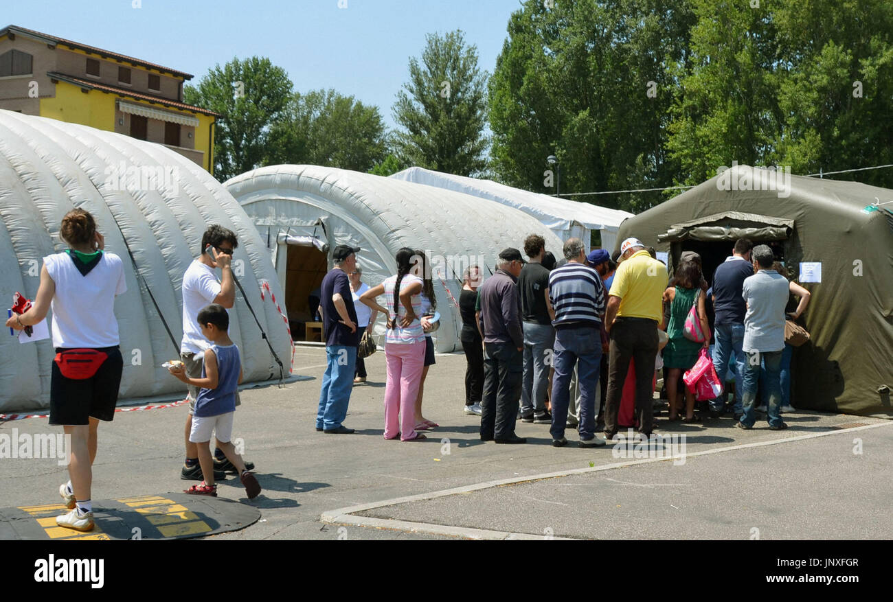 MEDOLLA, Italy - Earthquake survivors line up for meal tickets at a ...
