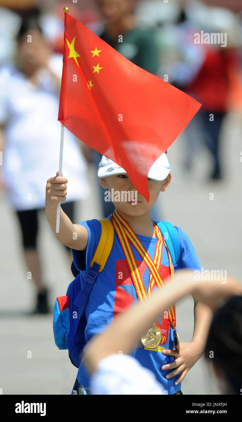 BEIJING, China - A child holding the Chinese national flag poses for a ...
