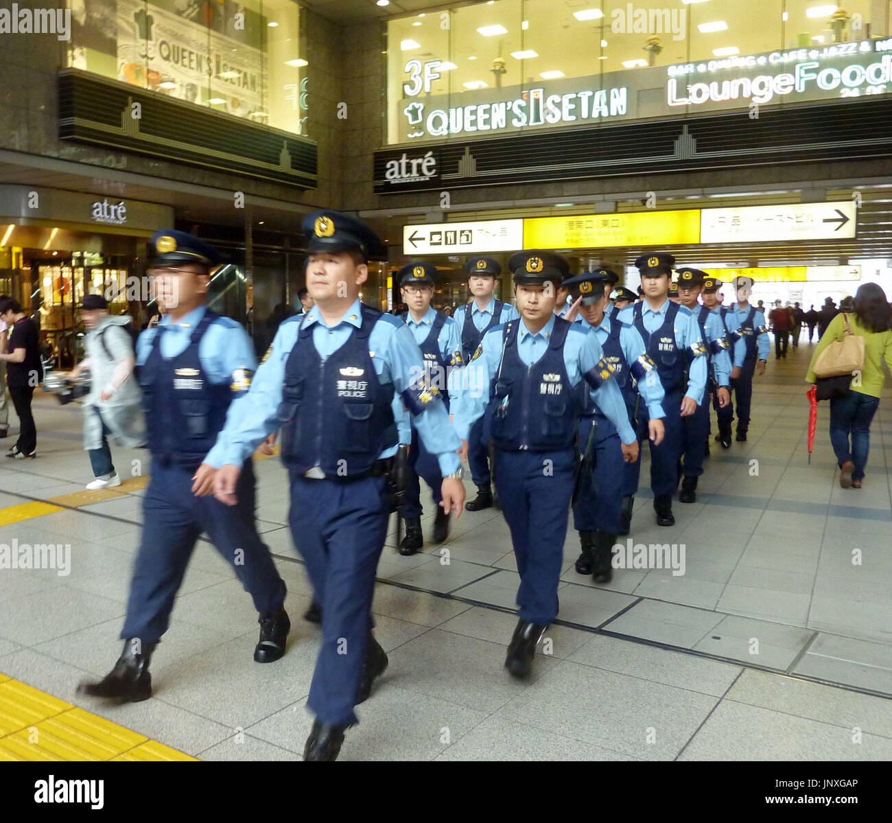 TOKYO, Japan - Police officers leave for a patrol from JR Shinagawa ...