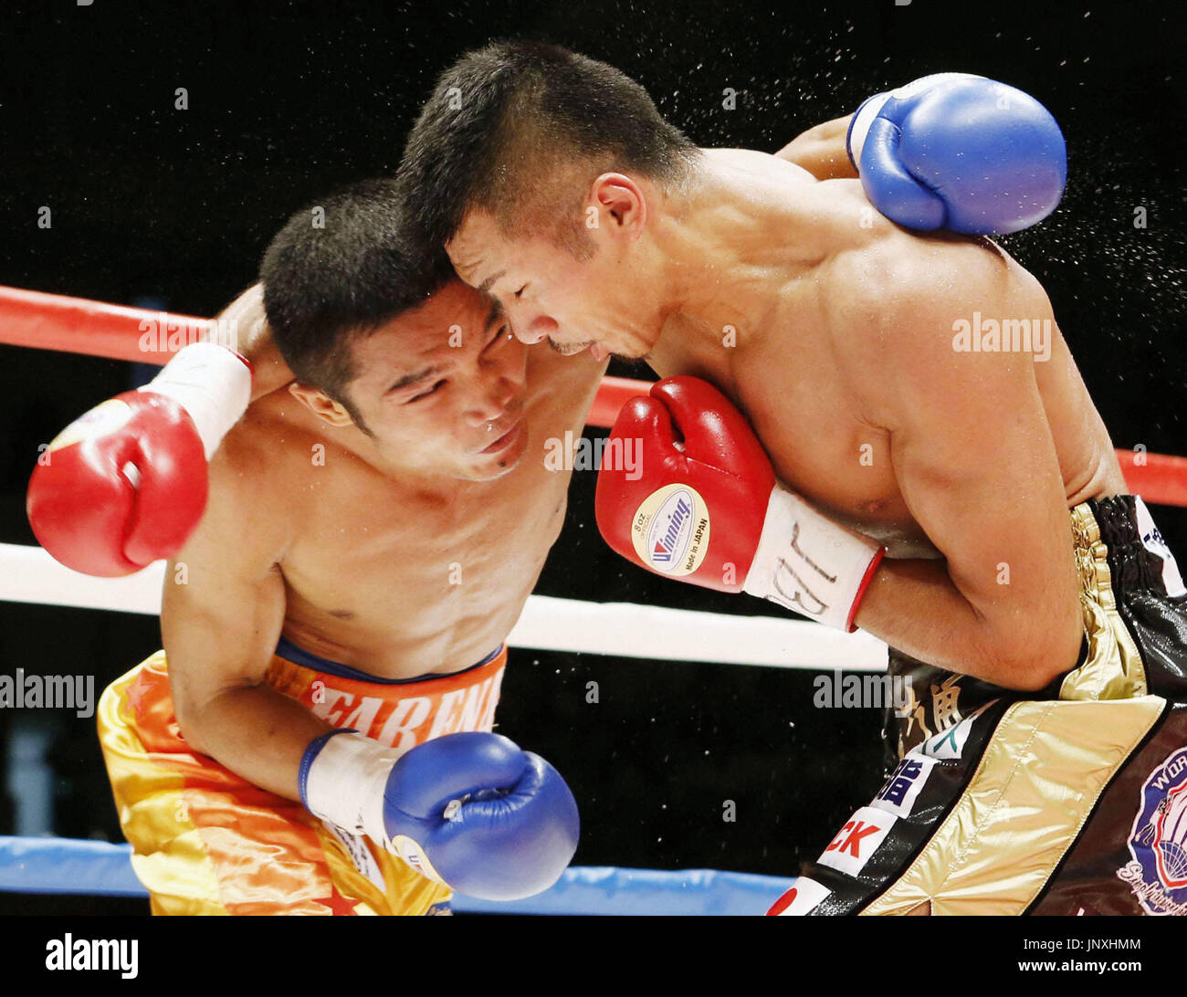 KASUKABE, Japan - Filipino challenger Michael Farenas (L) headbutts WBA ...