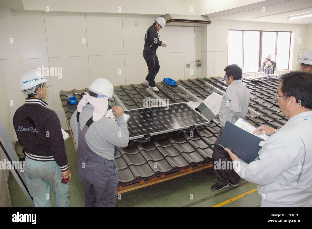 TOKYO, Japan - Japanese workers undergo training to set up a solar ...