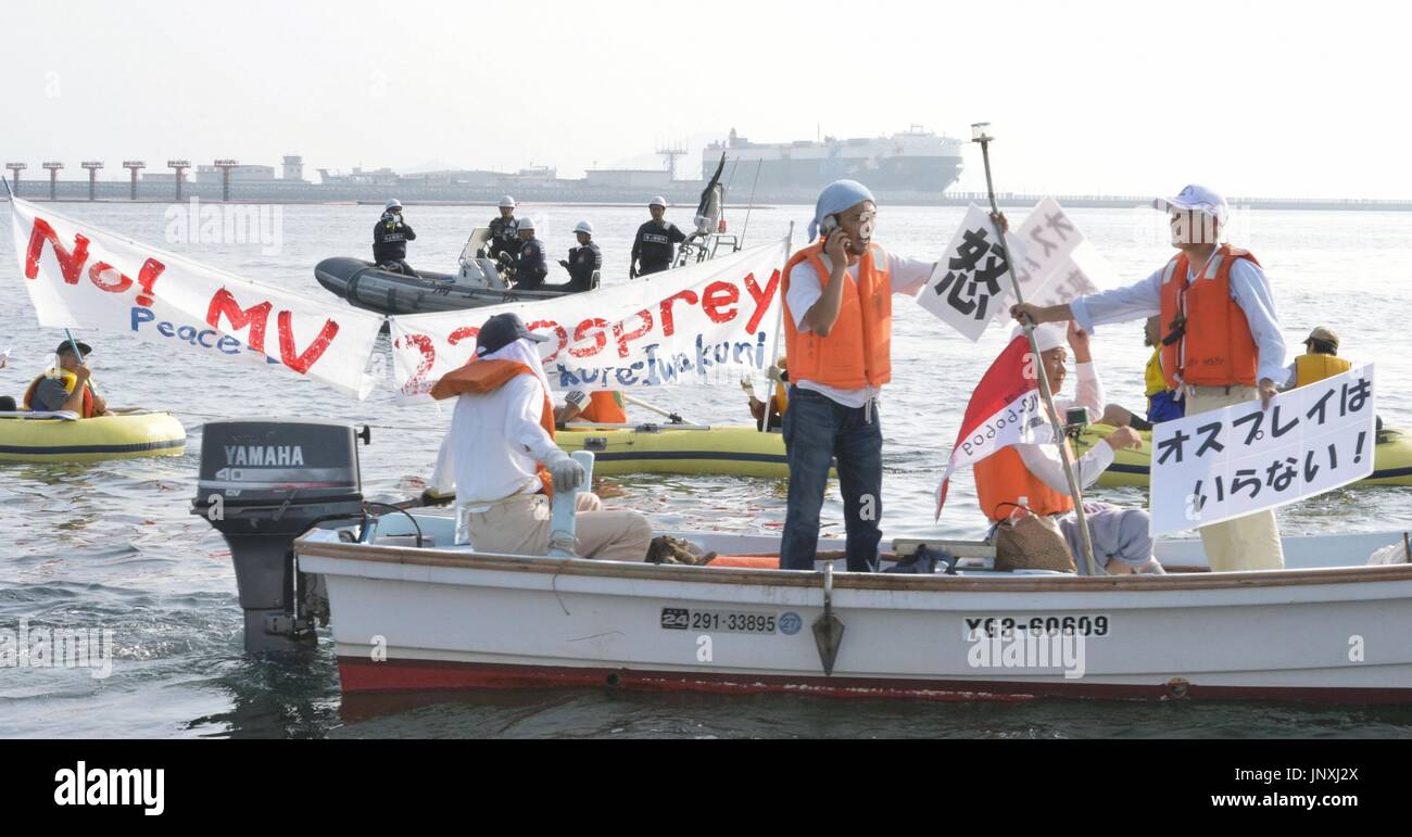 IWAKUNI, Japan - People stage a demonstration aboard a boat off the ...