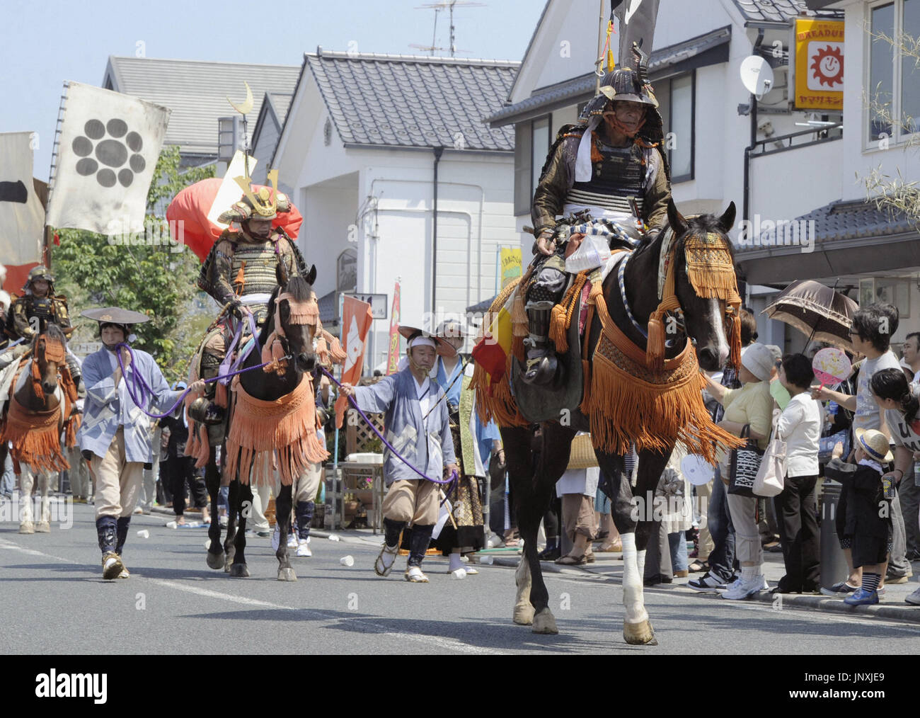 SOMA, Japan - A warrior procession marches on a street in Soma ...
