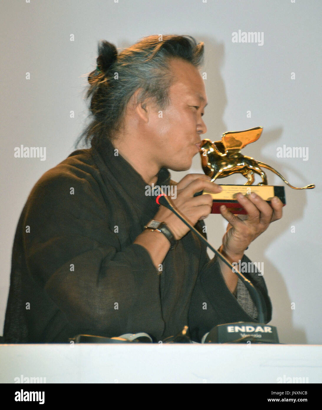 VENICE, Italy - South Korean film director Kim Ki Duk kisses his trophy ...