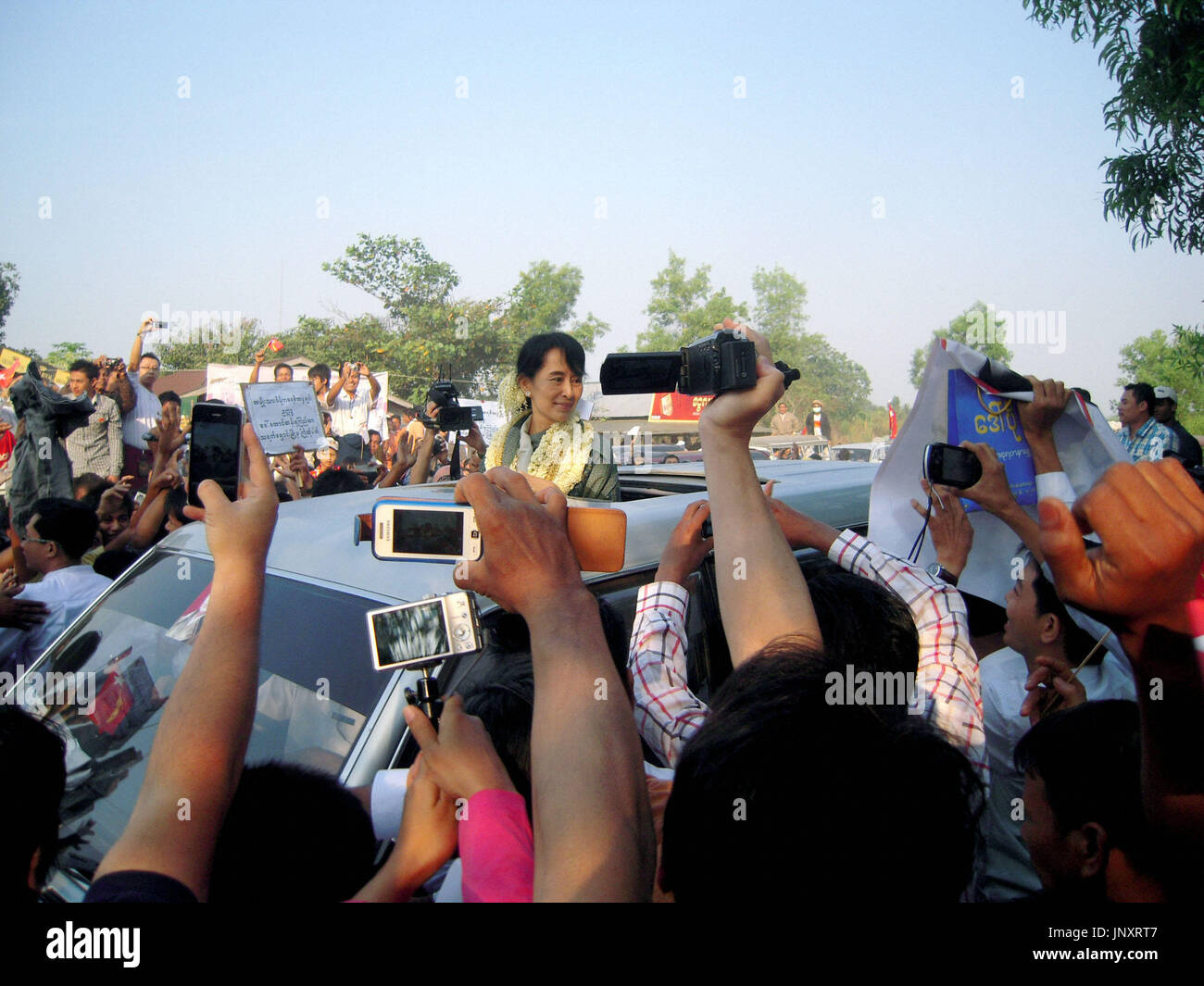 DAWEI, Myanmar - People along a road take photos of Myanmar democracy ...