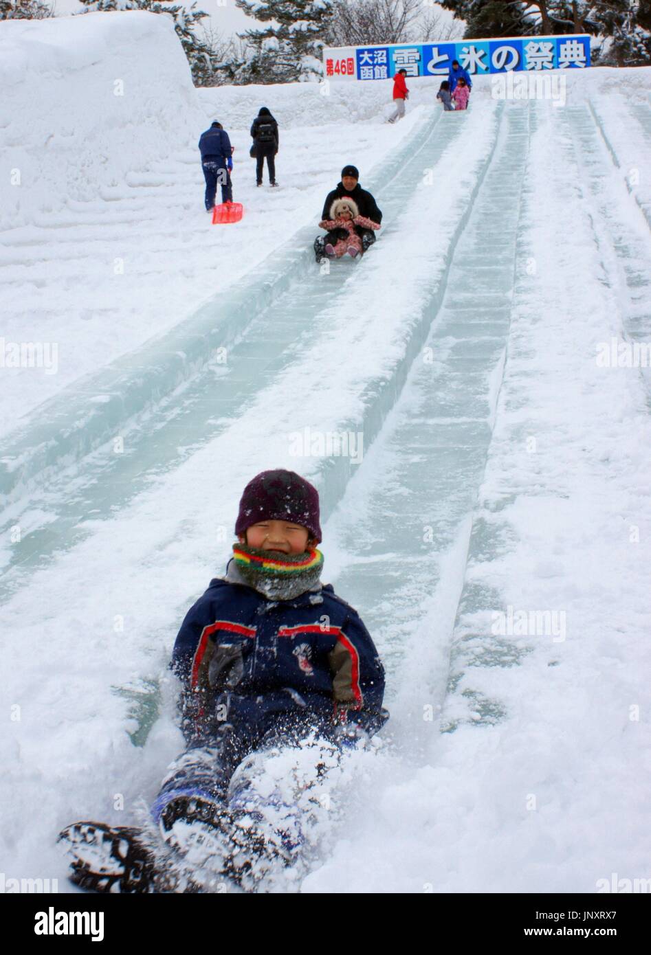 HAKODATE, Japan - Children go down a 20-meter slide made of ice during ...