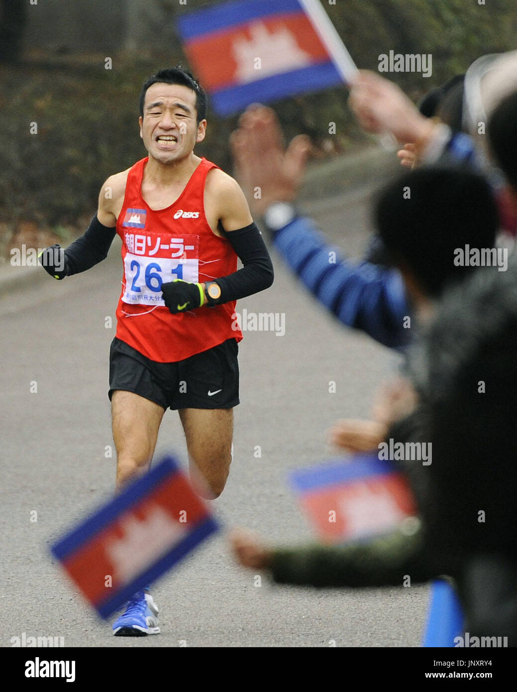OITA, Japan - Spectators wave Cambodian flags on a road as comedian ...
