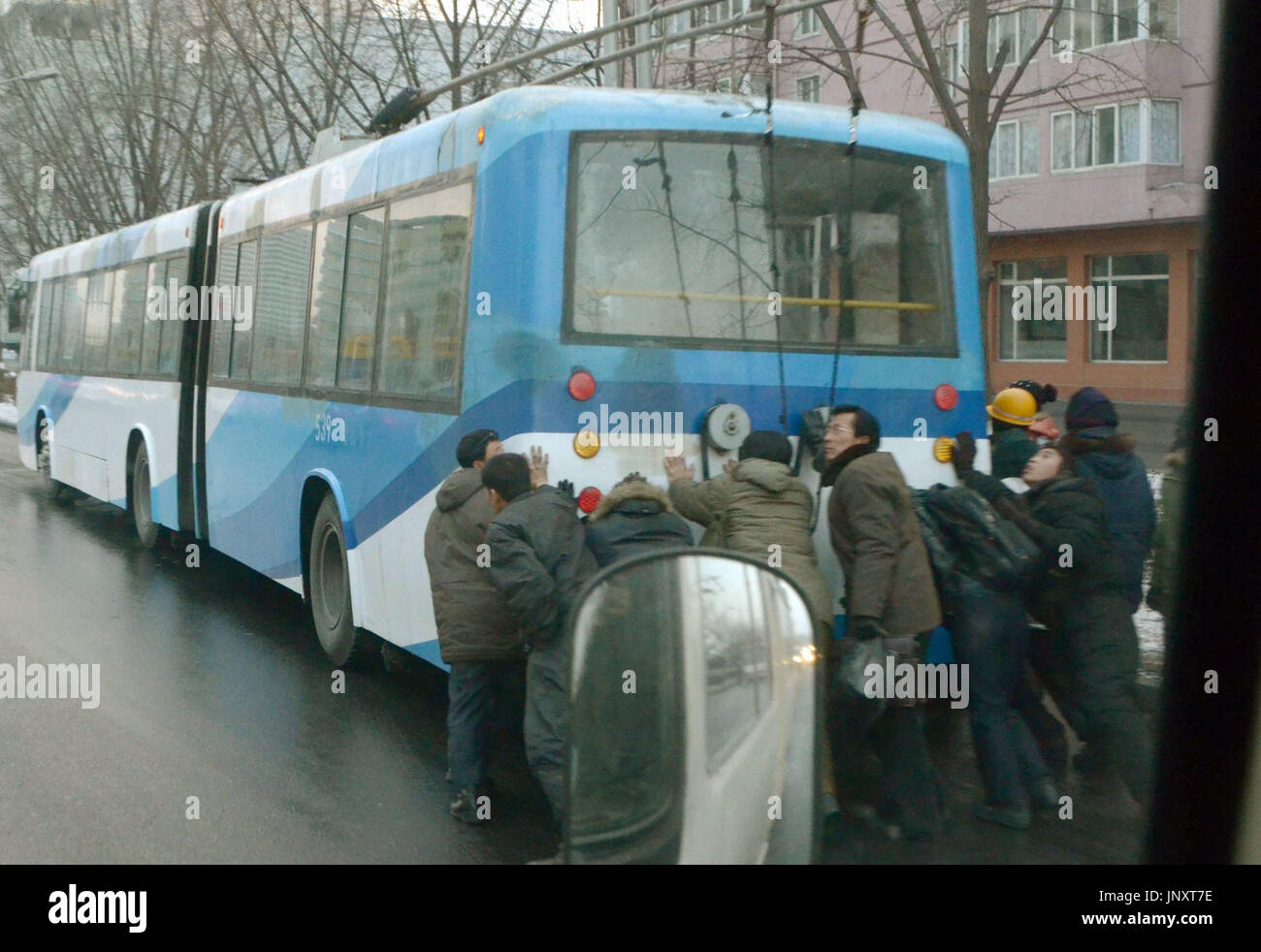 PYONGYANG, North Korea - People are seen pushing an electricity-driven ...