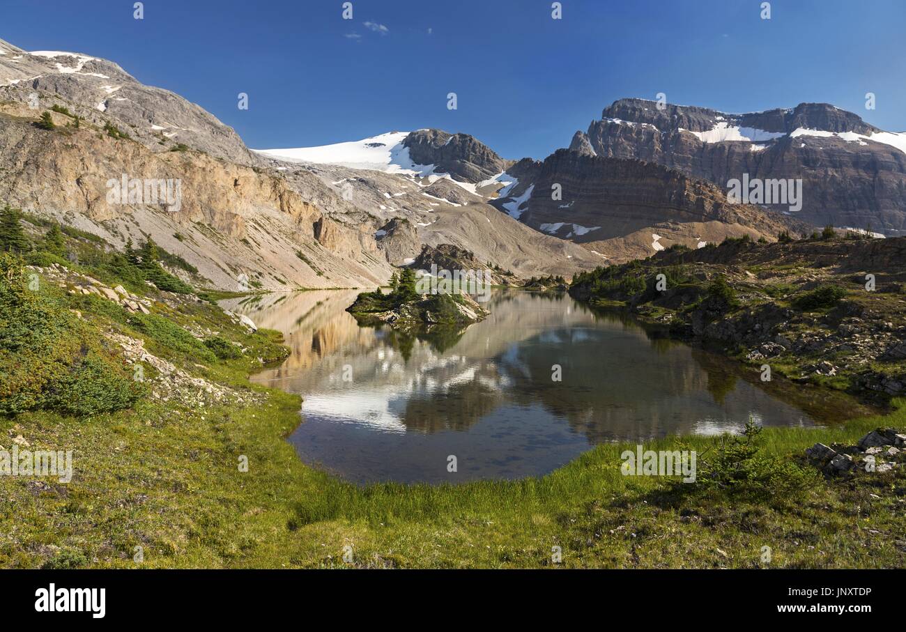 Scenic landscape view Blue Alpine Lake and Snowy Rocky Mountain Peak ...