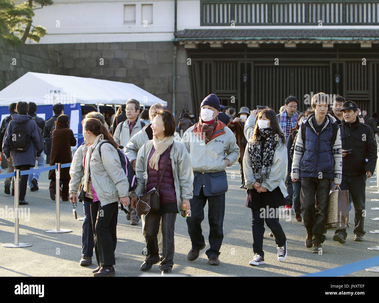 TOKYO, Japan - People line up in front of the Imperial Palace in Tokyo ...