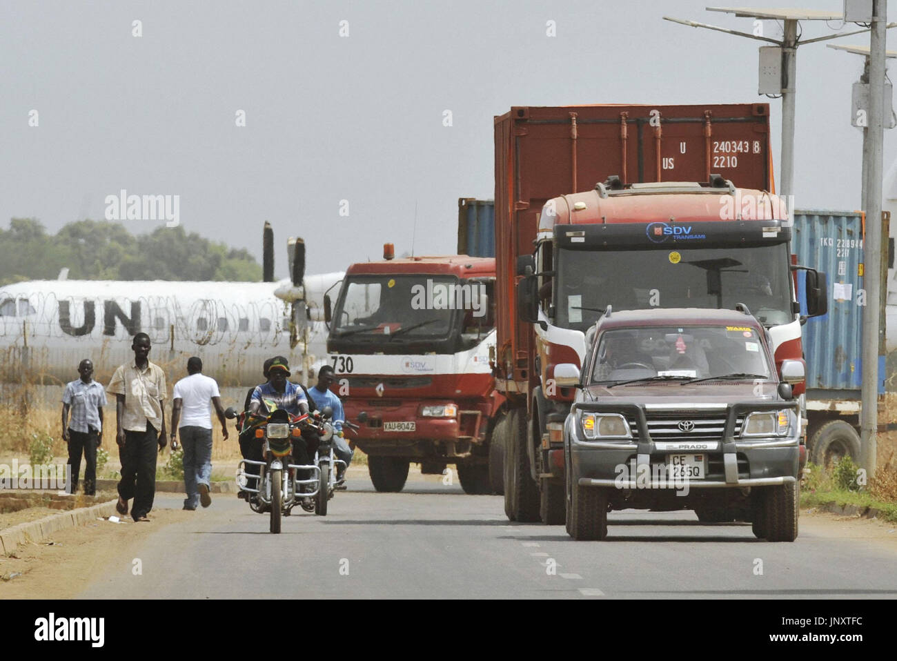 JUBA, South Sudan - Vehicles take materials from Juba airport in South ...