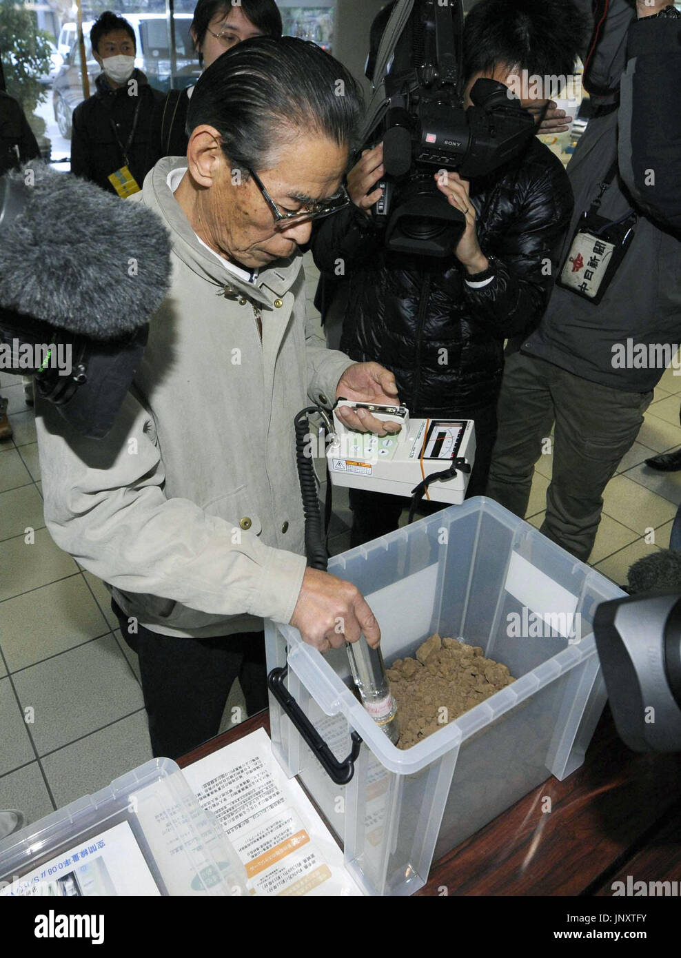 SHIMADA, Japan - A local resident measures radiation levels at the city ...