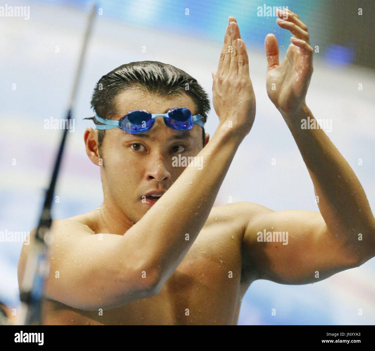 TOKYO, Japan - Kosuke Kitajima claps his hands after winning the men's 200-meter breaststroke at ...
