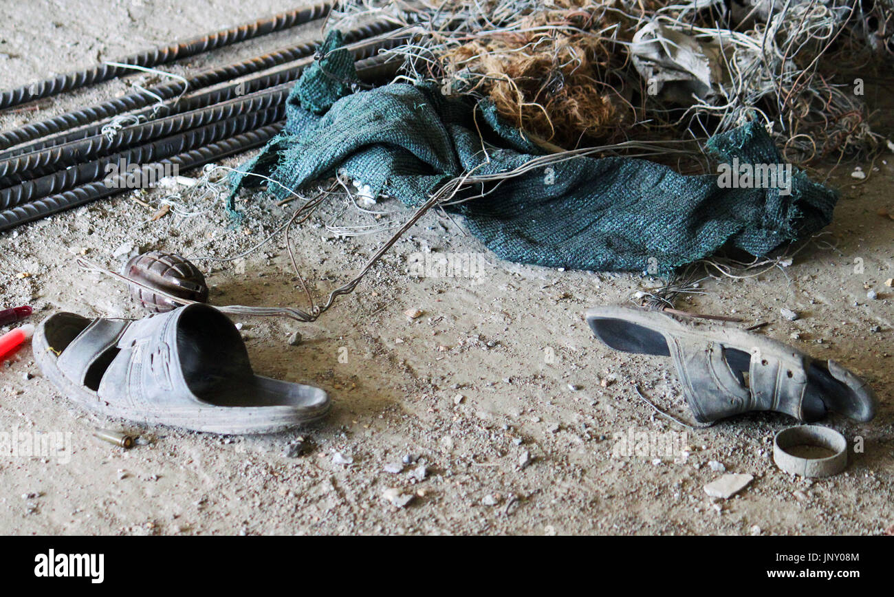 KABUL, Afghanistan - Photo shows an unused grenade and sandals left ...