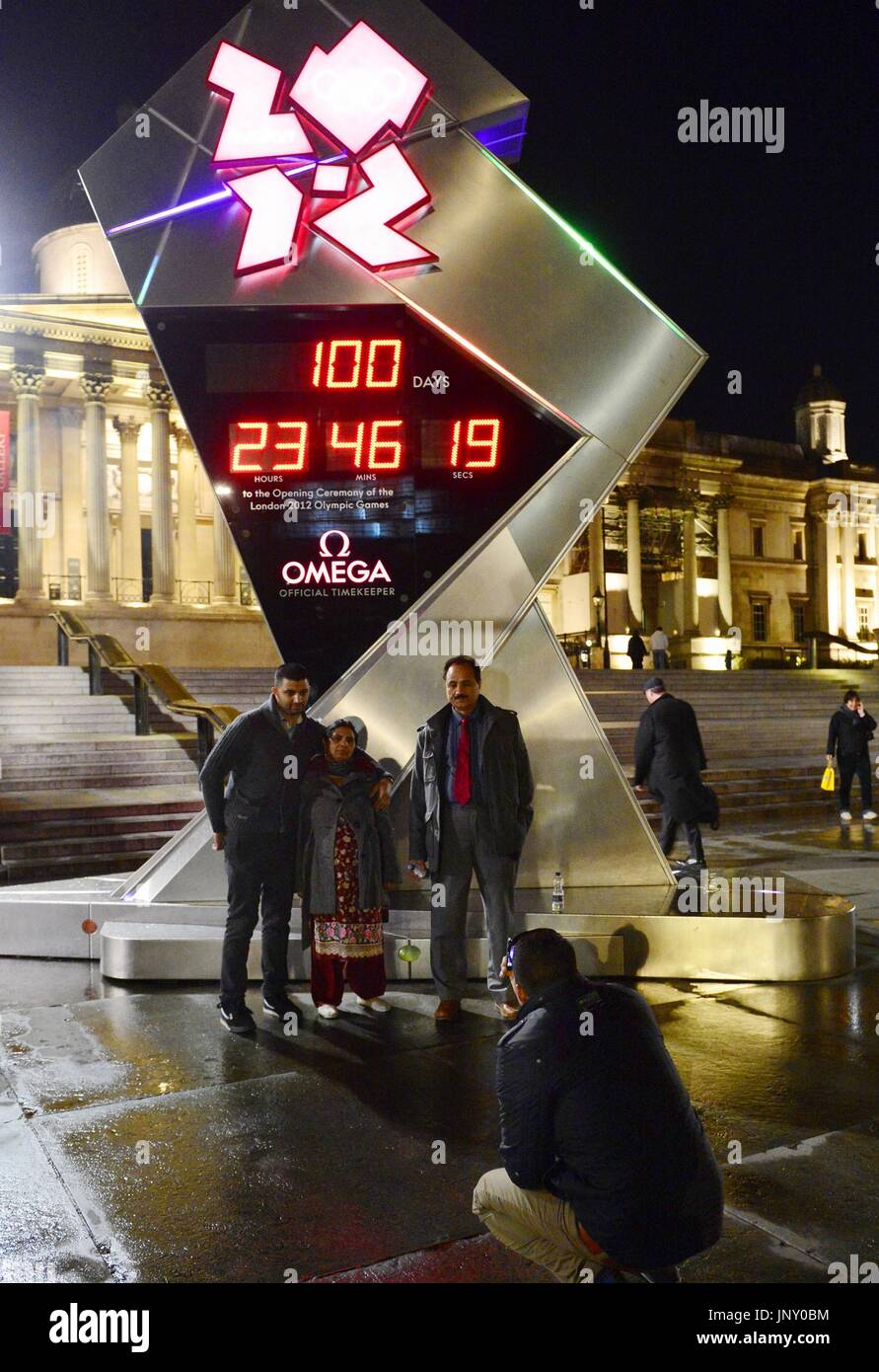 LONDON, Britain - People pose for photos in front of the Olympic ...