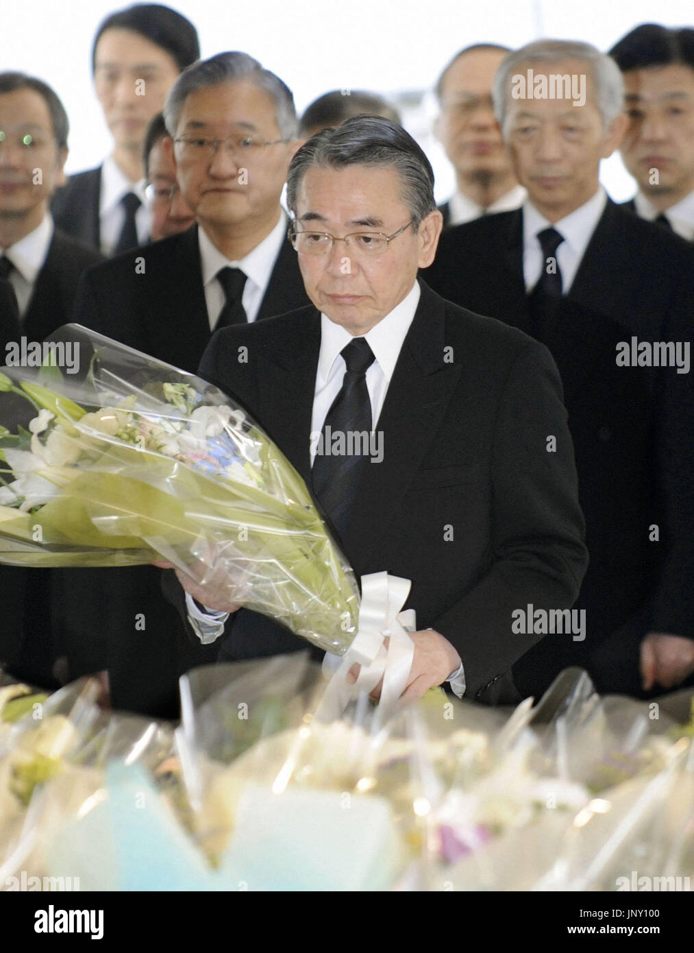 OSAKA, Japan - West Japan Railway Co. President Takayuki Sasaki offers flowers at an altar at ...