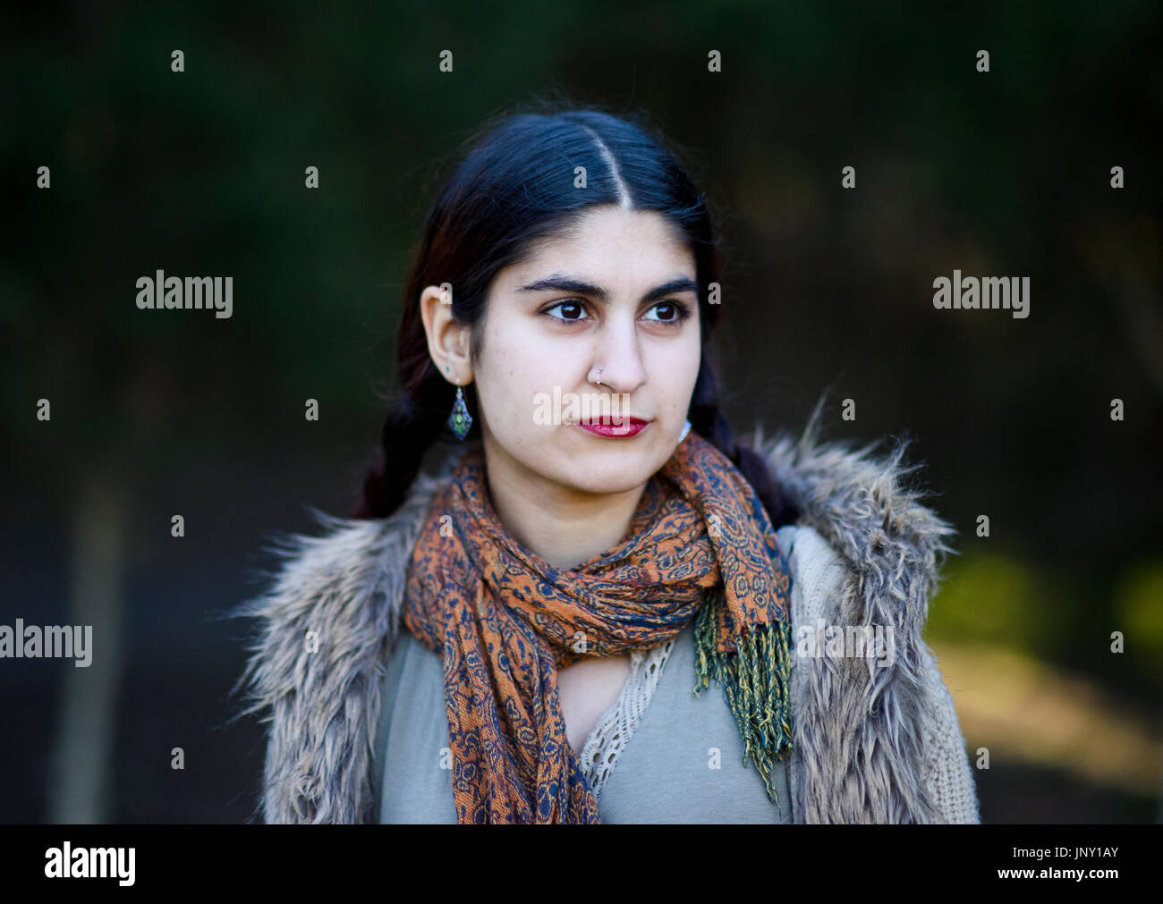 Teenage Persian girl walking in the park on an autumn day Stock Photo ...