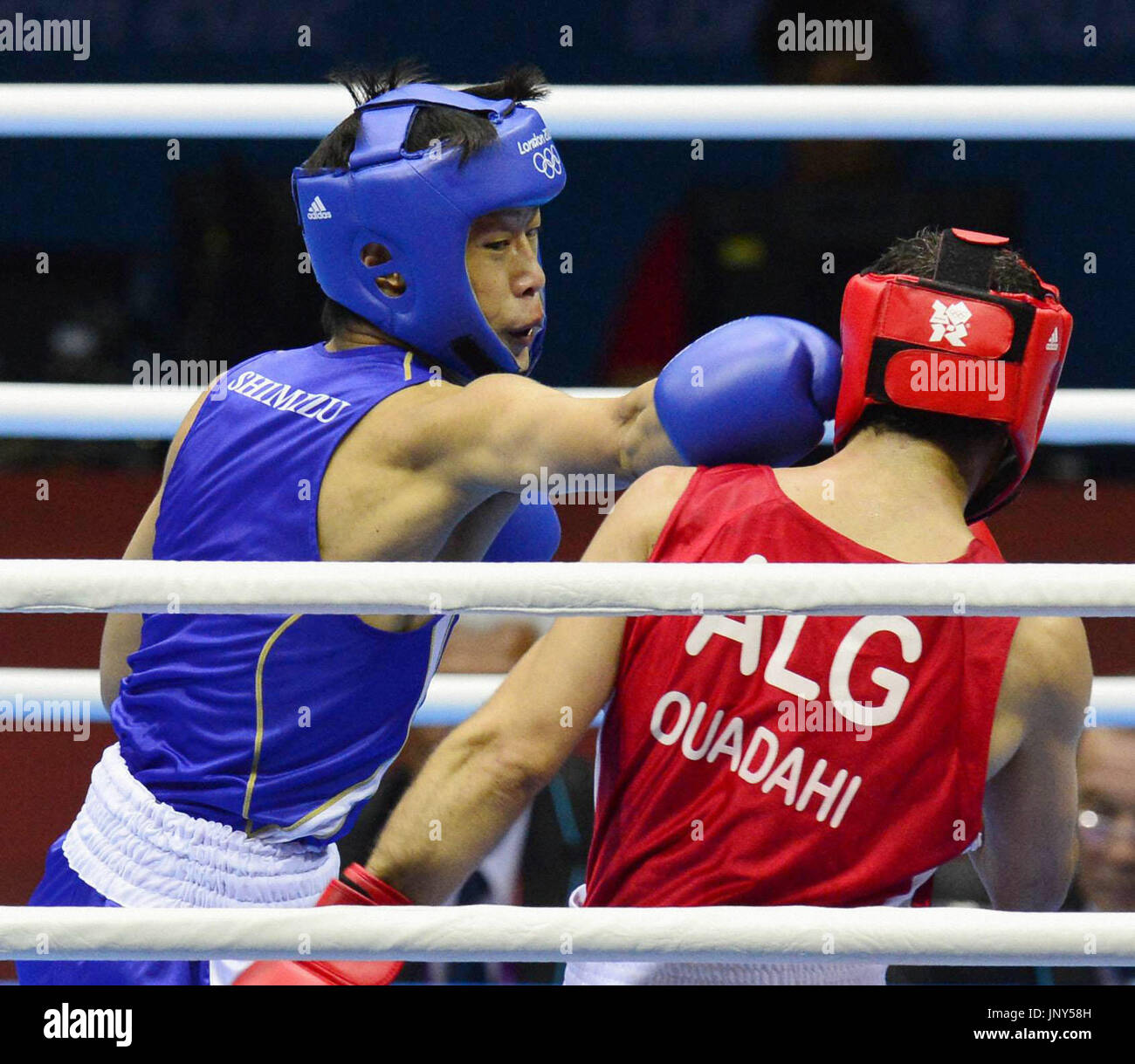 LONDON, Britain - Japan's Satoshi Shimizu (L) punches Algeria's Mohamed ...