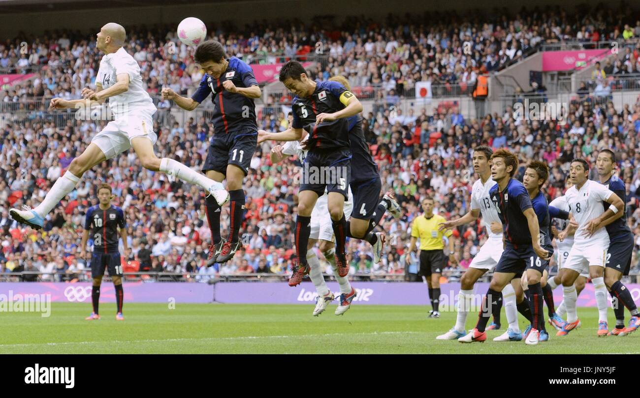 LONDON, Britain - Japan's Kensuke Nagai (11) and Maya Yoshida (5) try ...