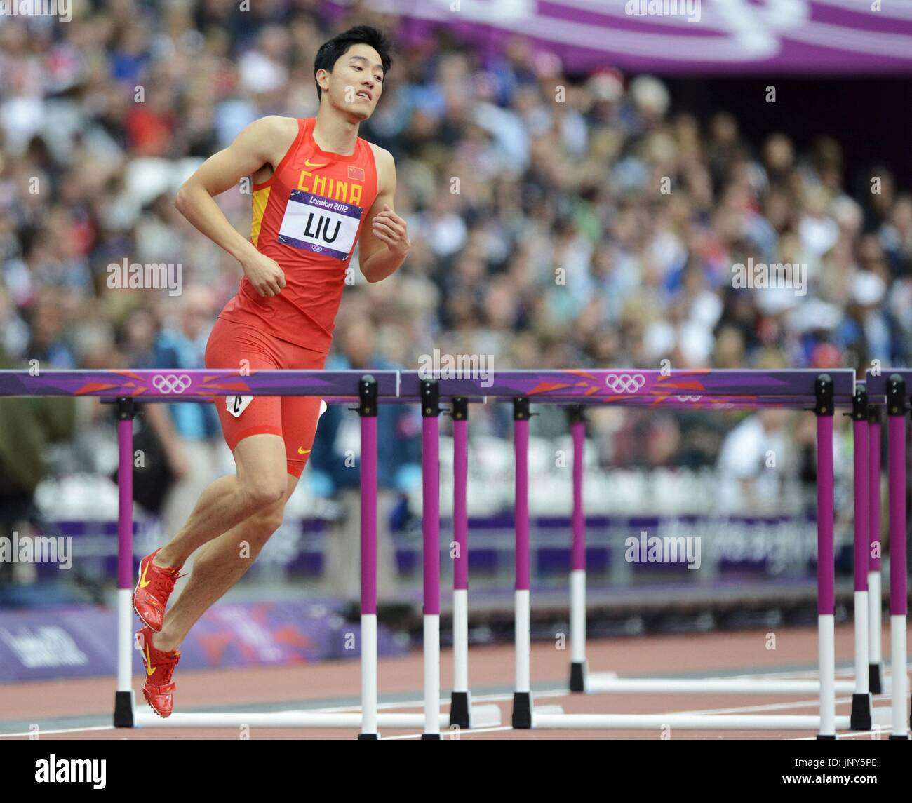 LONDON, Britain - China's Liu Xiang hops on one foot outside his lane ...