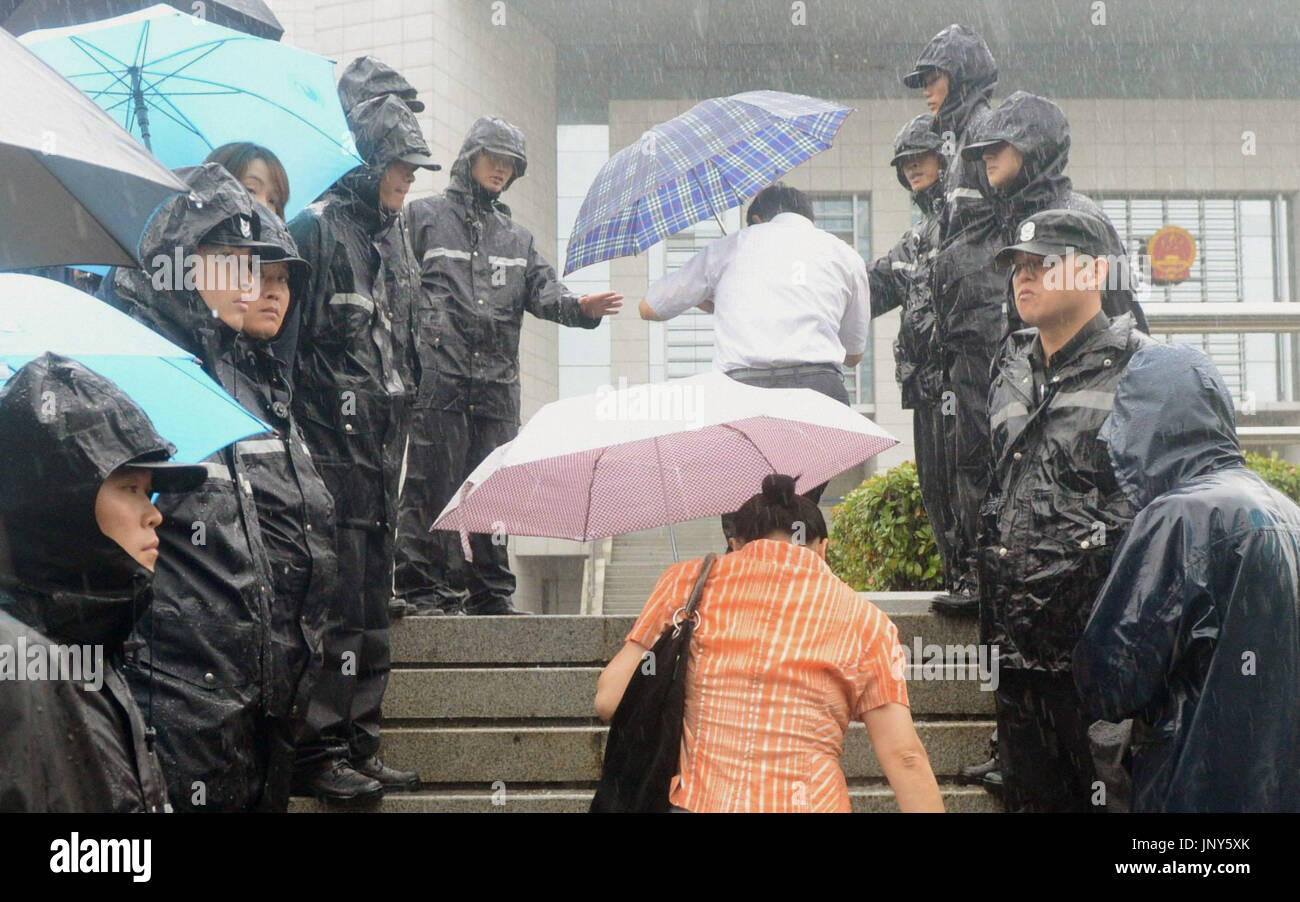 HEFEI, China - Police officers stand guard as people believed to be ...
