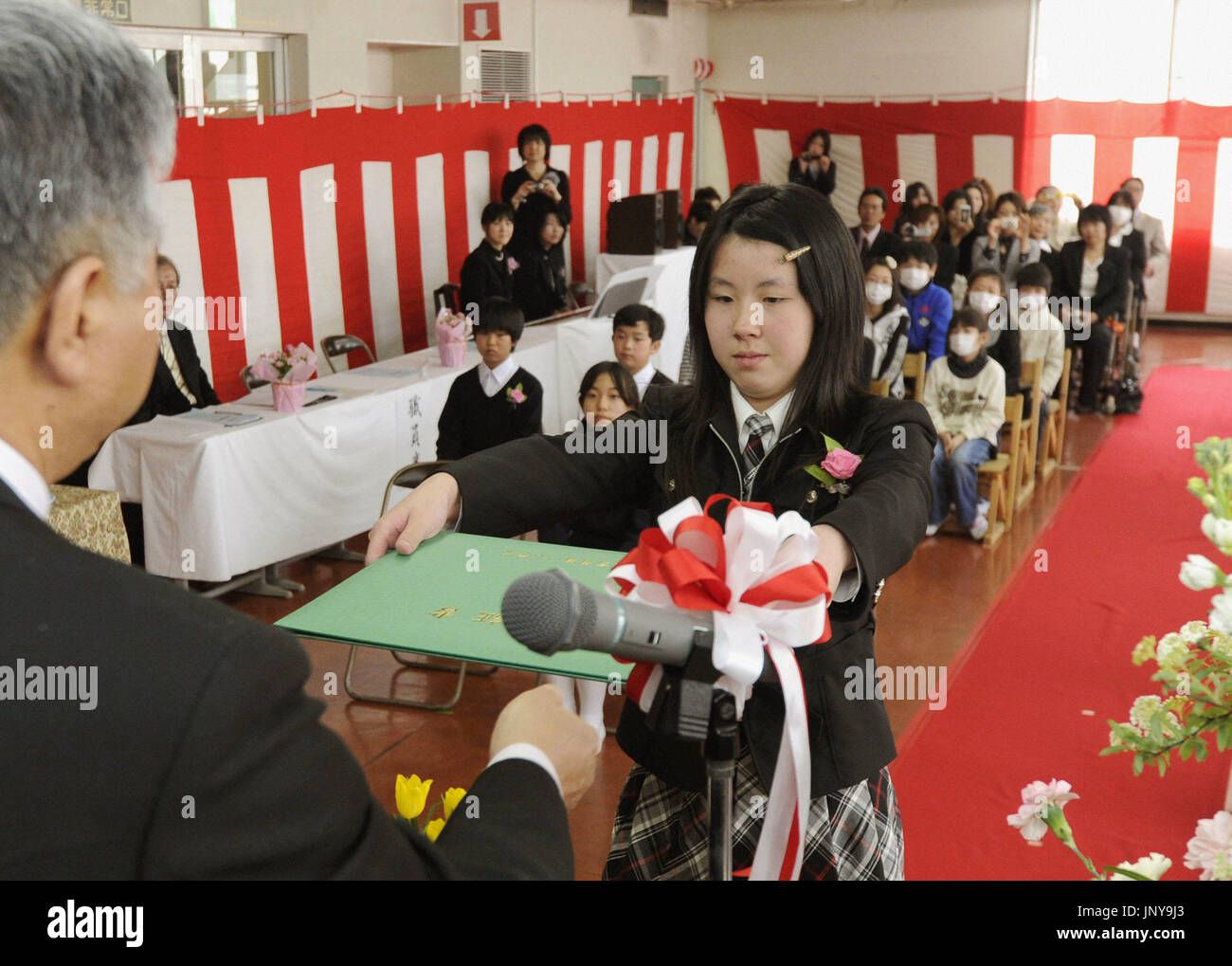 MIHARU, Japan - A girl receives a graduation certificate during a ...