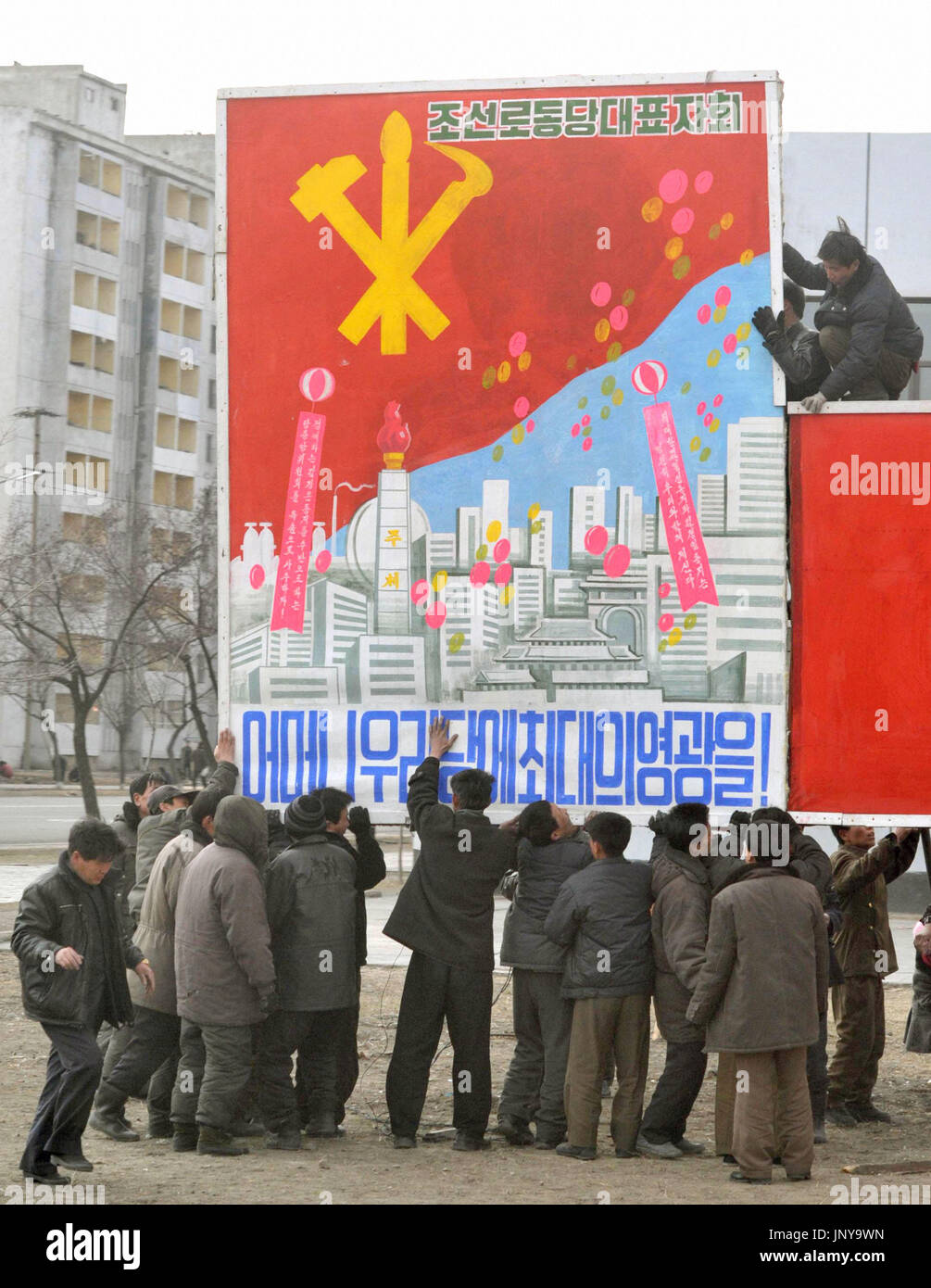 PYONGYANG, North Korea - People set up a propaganda painting on the ...