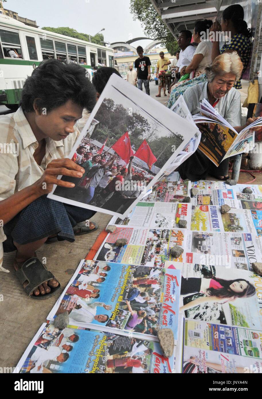 YANGON, Myanmar - People voraciously read newspapers reporting on the ...