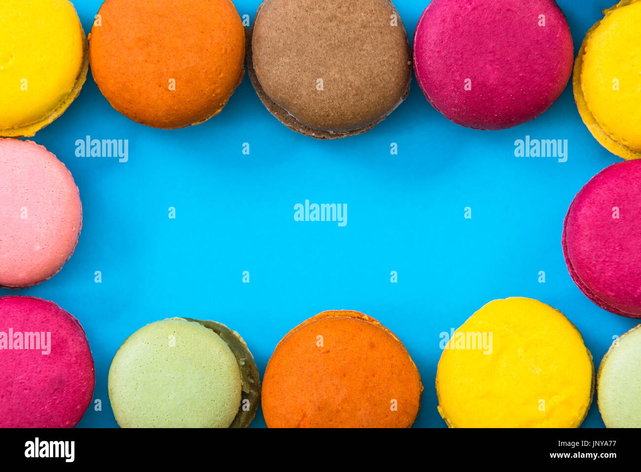 Border background, colorful macaroon cookies, top view Stock Photo - Alamy