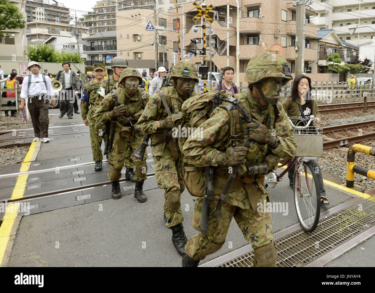 TOKYO, Japan - Rifle-carrying Ground Self-Defense Force troops in ...