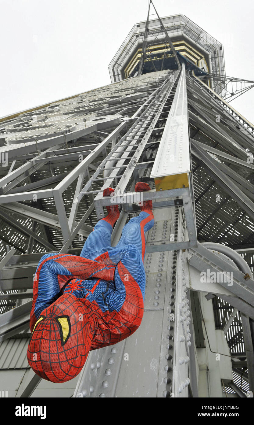 OSAKA, Japan - Spider-Man hangs upside down at Tsutenkaku tower in ...