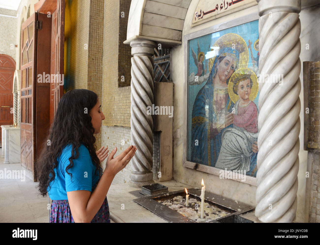 CAIRO, Egypt - A Coptic woman prays at a church in Cairo on June 26 ...