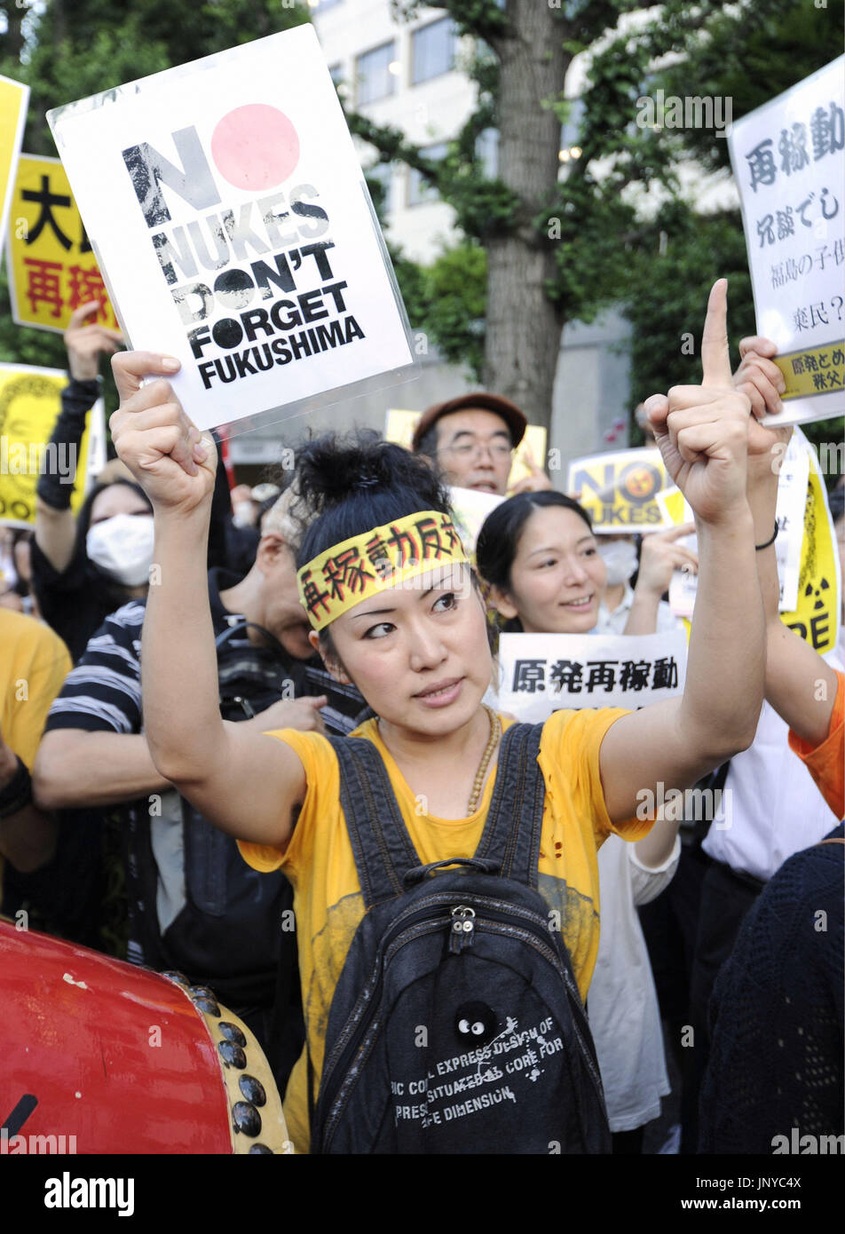 TOKYO, Japan - A woman protests in front of the prime minister's office ...
