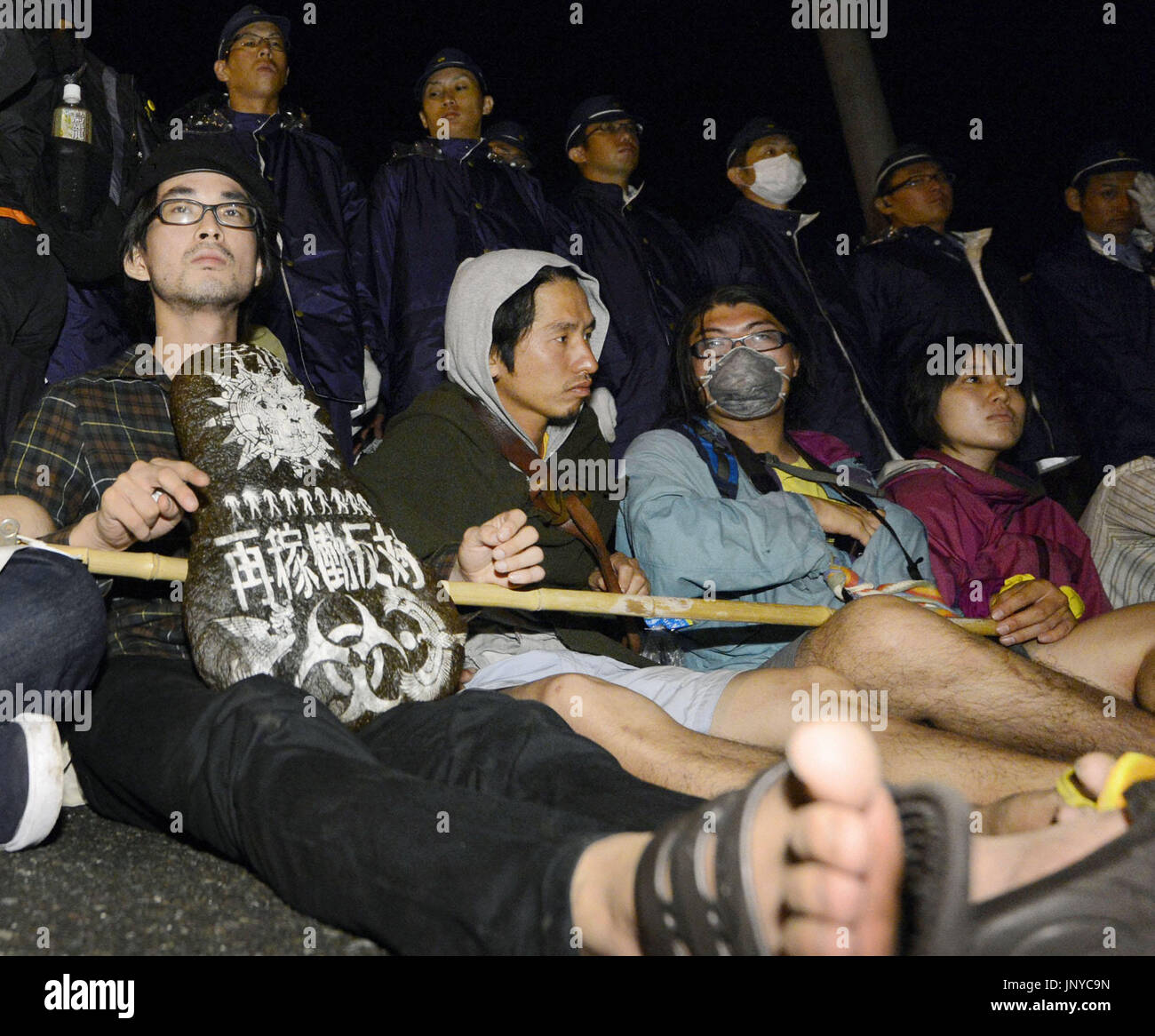 OI, Japan - People sit on a road around the Oi nuclear power plant in ...