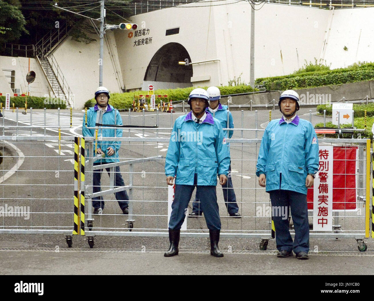 OI, Japan - Security guards stand near the entrance to Kansai Electric ...