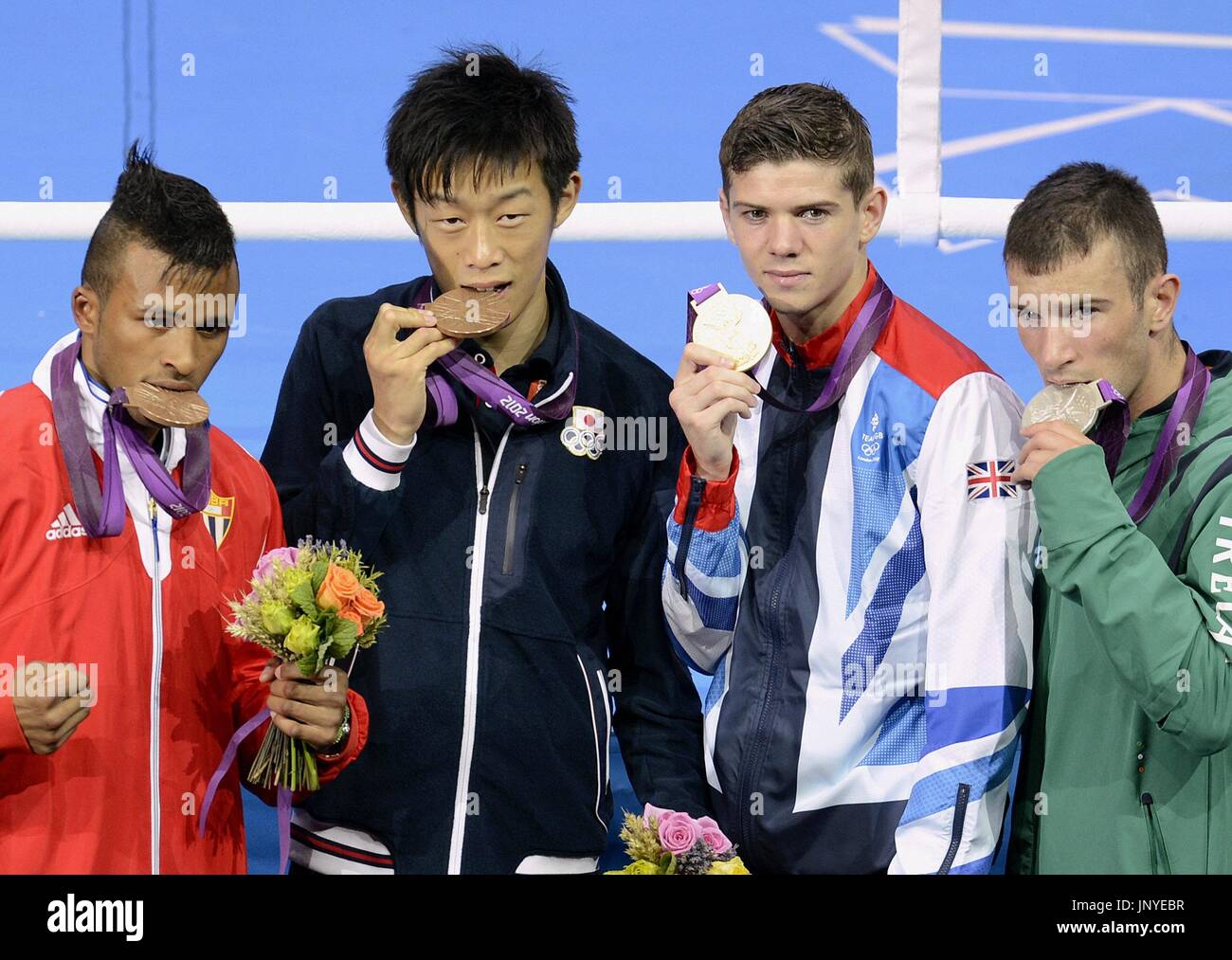LONDON, Britain - Japan's Satoshi Shimizu (2nd from L) bites his bronze ...