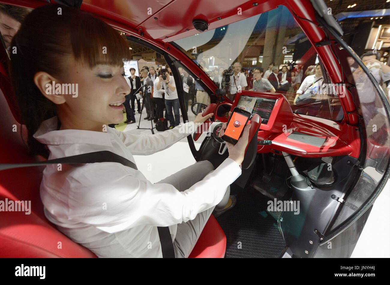 CHIBA, Japan - A woman demonstrates Toyota Motor Corp.'s "Smart Insect ...