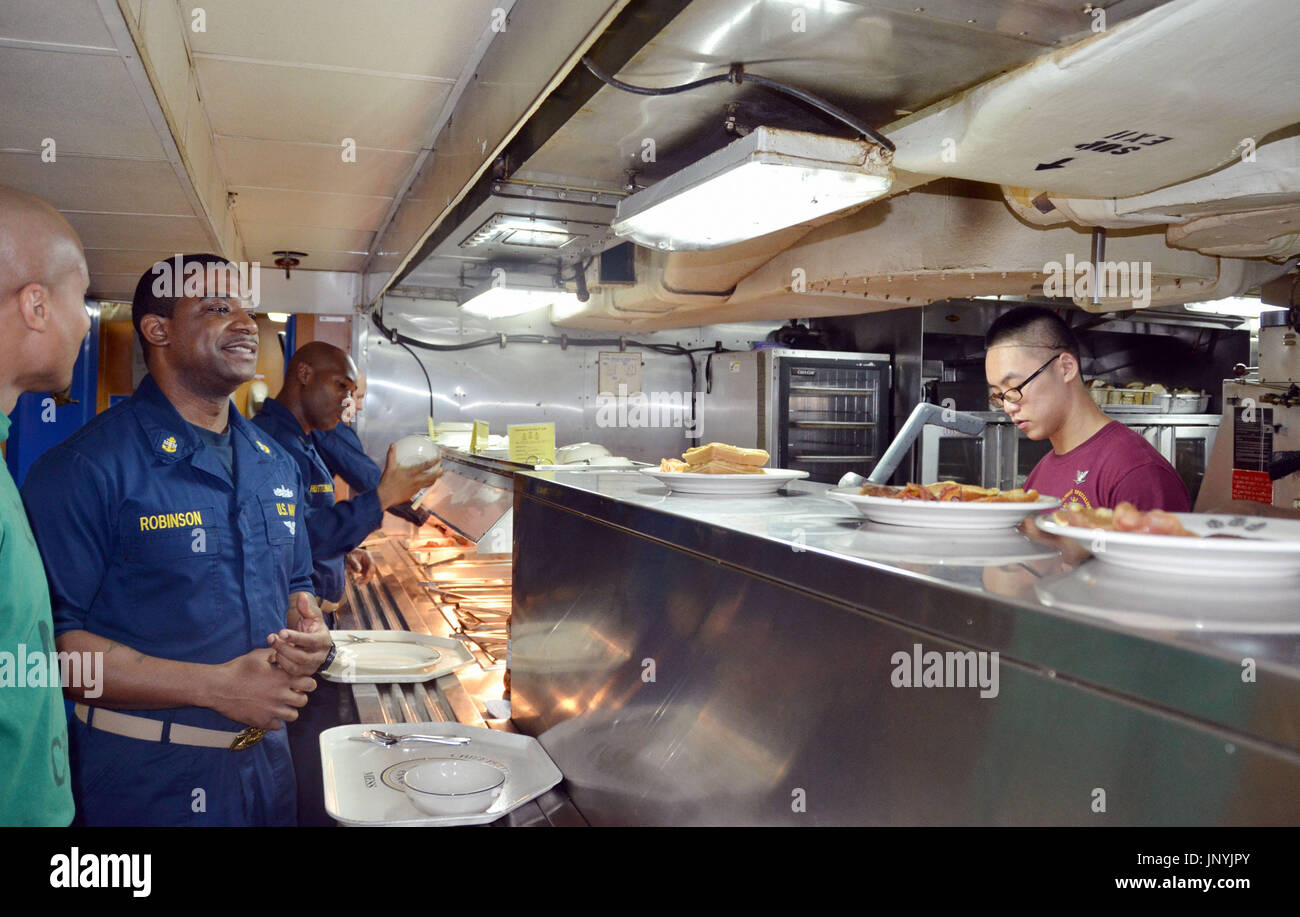 CAIRO, Egypt - Crew members queue for a meal in the cafeteria of the U ...