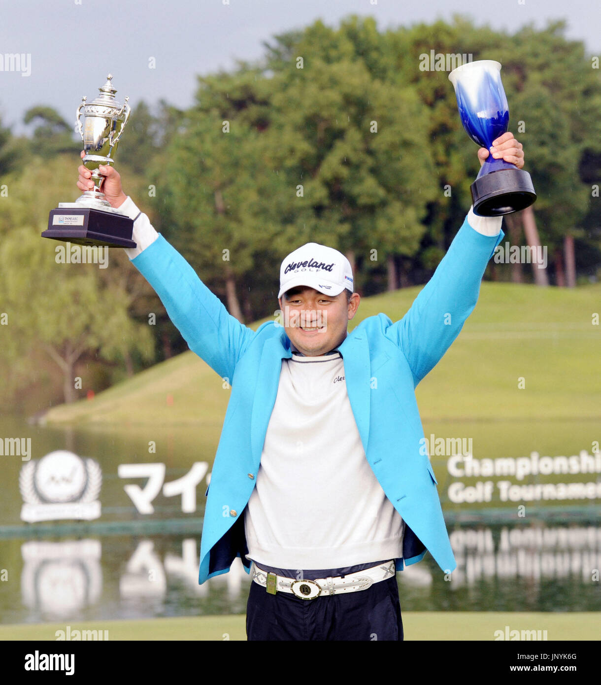 KATO, Japan - American Han Lee holds the victor's trophies after the ...