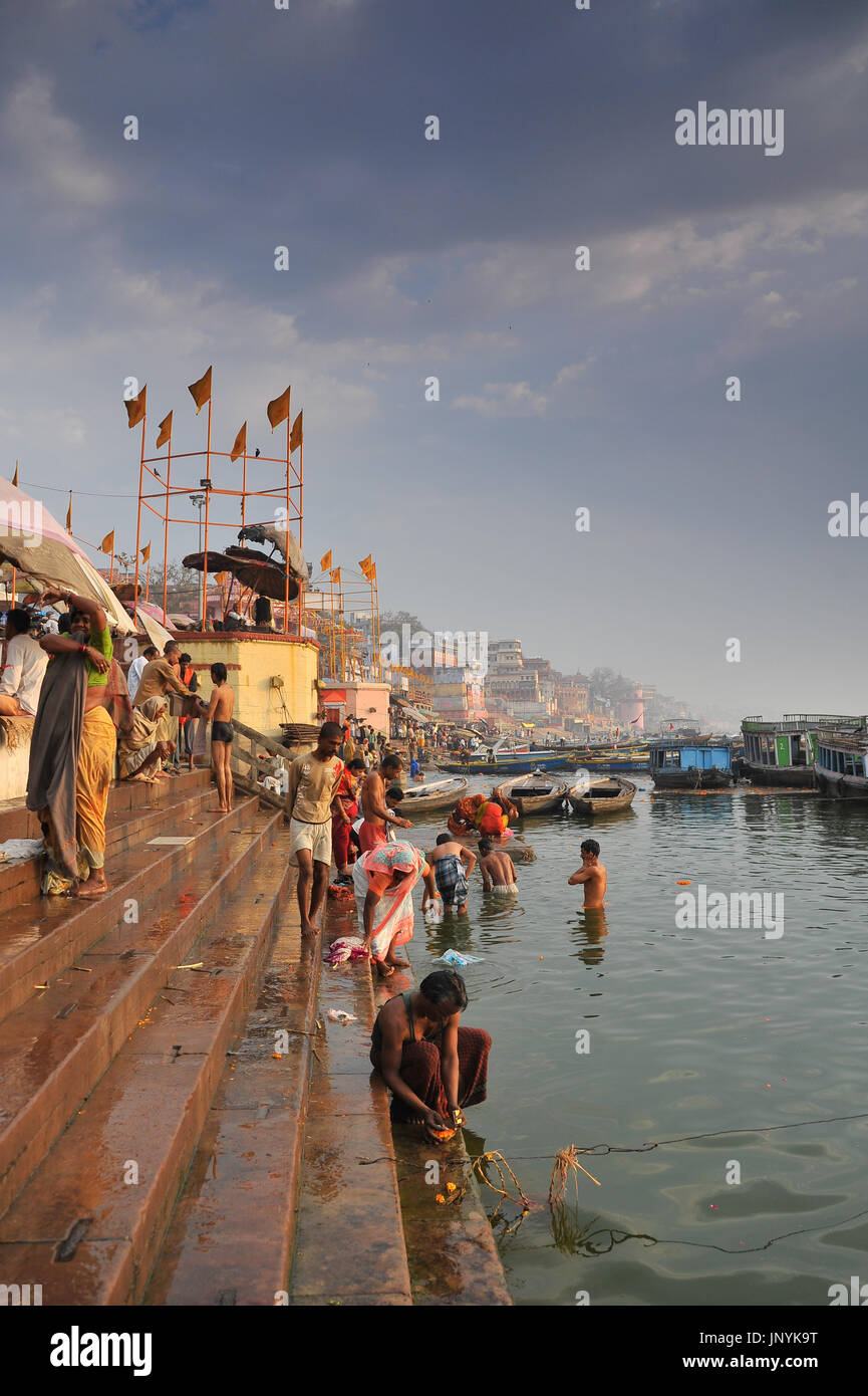 Scene of the Ghats in Varanasi, with pilgrims bathing and lighting ...