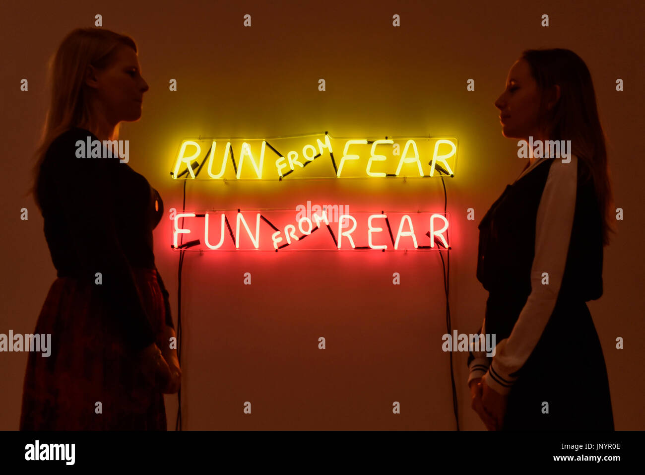 London, UK. 31 July 2017. Gallery staff in front of a neon work called ...
