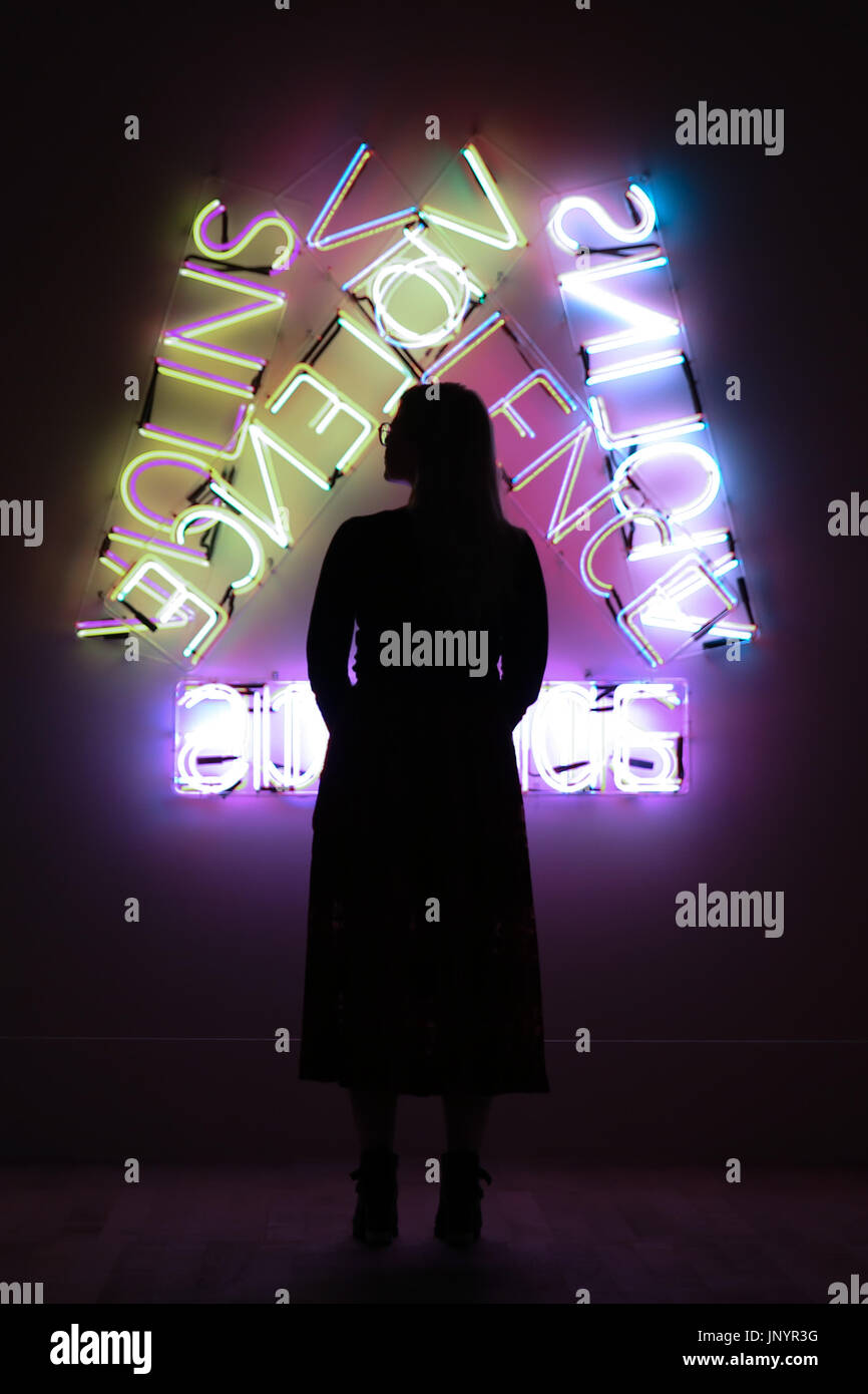 A museum staff looks at Bruce Nauman's Bright neon sculptures - Violins ...