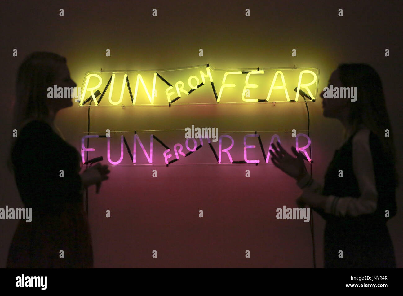 Museum staffs looks at Bruce Nauman's bright neon sculptures - Run from ...