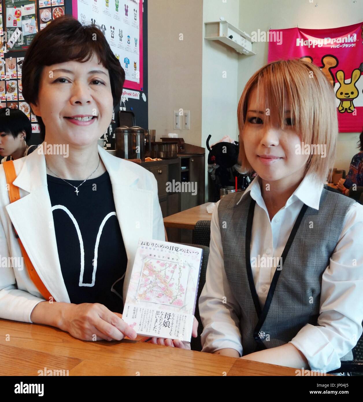 TOKYO, Japan - Kimiko Horimoto holds up a book she co-wrote with her ...
