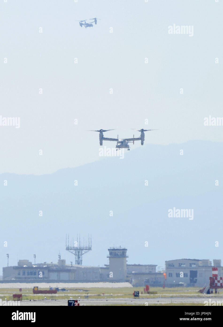IWAKUNI, Japan - Two of the U.S. Marine Corps' Osprey military aircraft ...