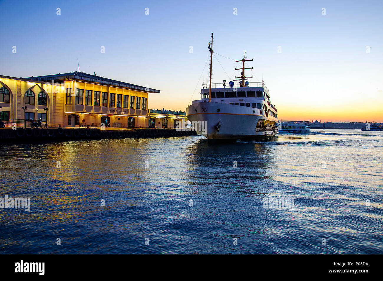 Passenger ferry arriving to port at evening time Stock Photo - Alamy