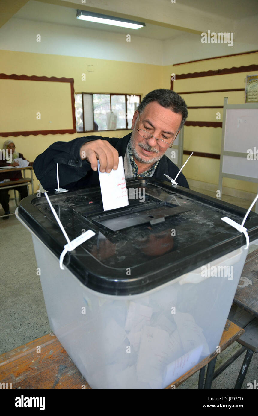 CAIRO, Egypt - A man casts his vote in a national referendum on a new ...