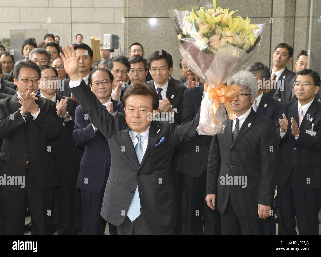 TOKYO, Japan - New Tokyo Gov. Naoki Inose receives a bouquet as he ...